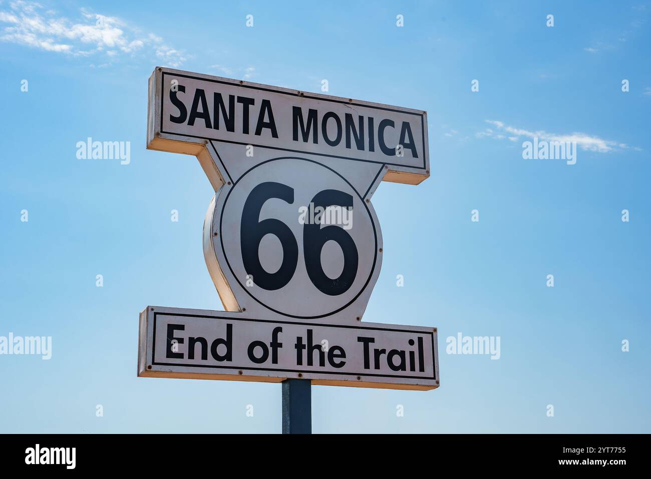 The iconic Route 66 End of the Trail sign stands against a clear blue ...