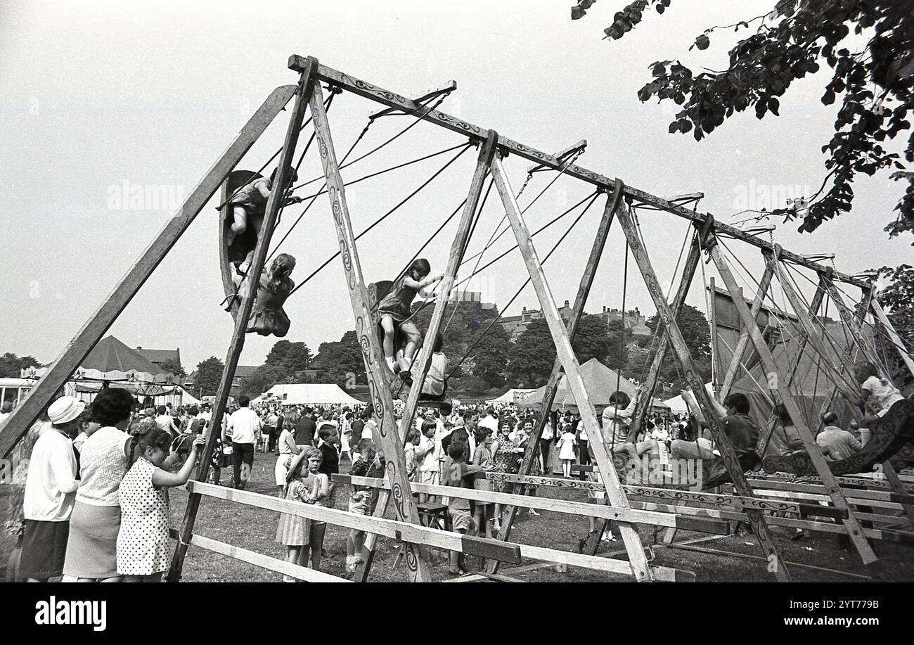 1968, historical, at a country fayre, children enjoying the two-seater ...