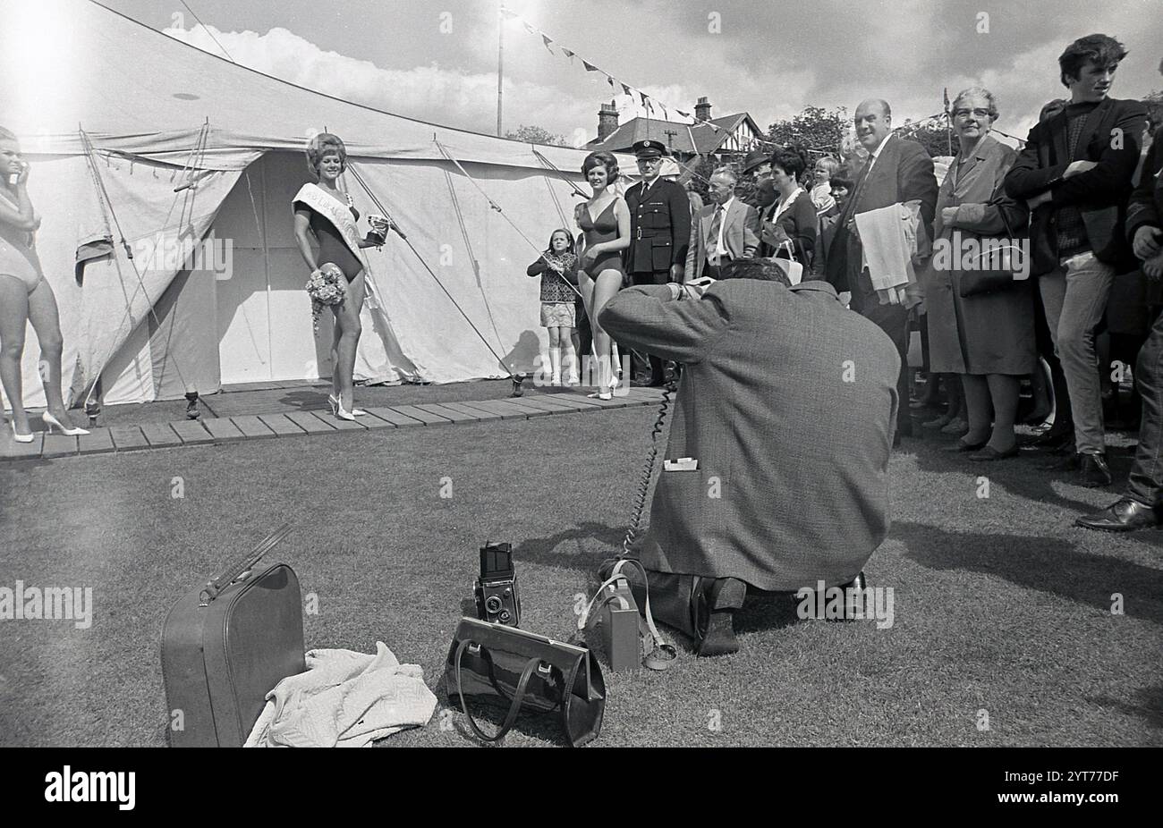 1968, historical, photographer kneeling down taking a picture of a ...