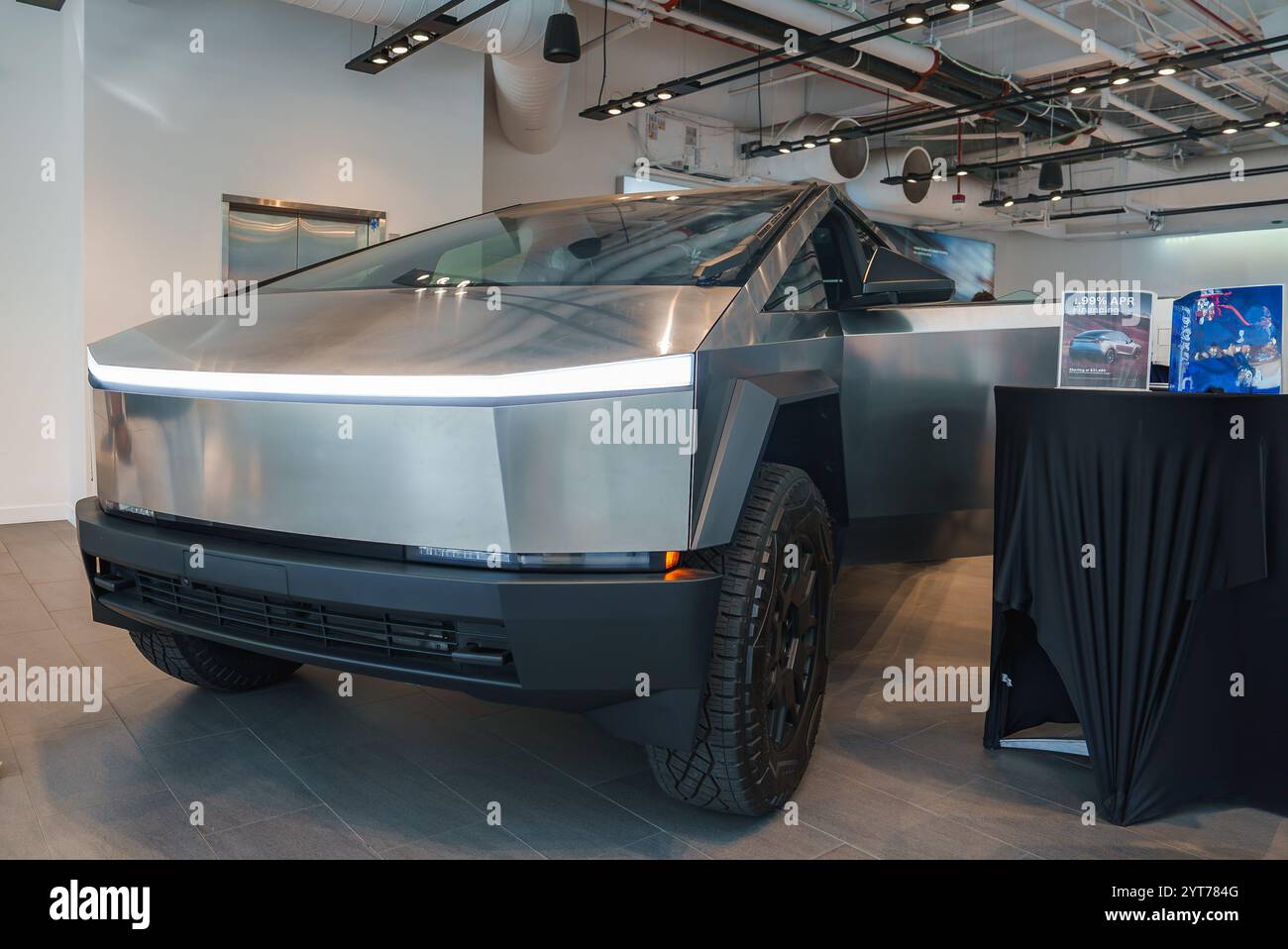 Futuristic Tesla Cybertruck in Modern Showroom with Industrial Lighting ...
