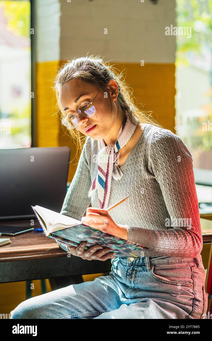 Female student taking notes hi-res stock photography and images - Alamy