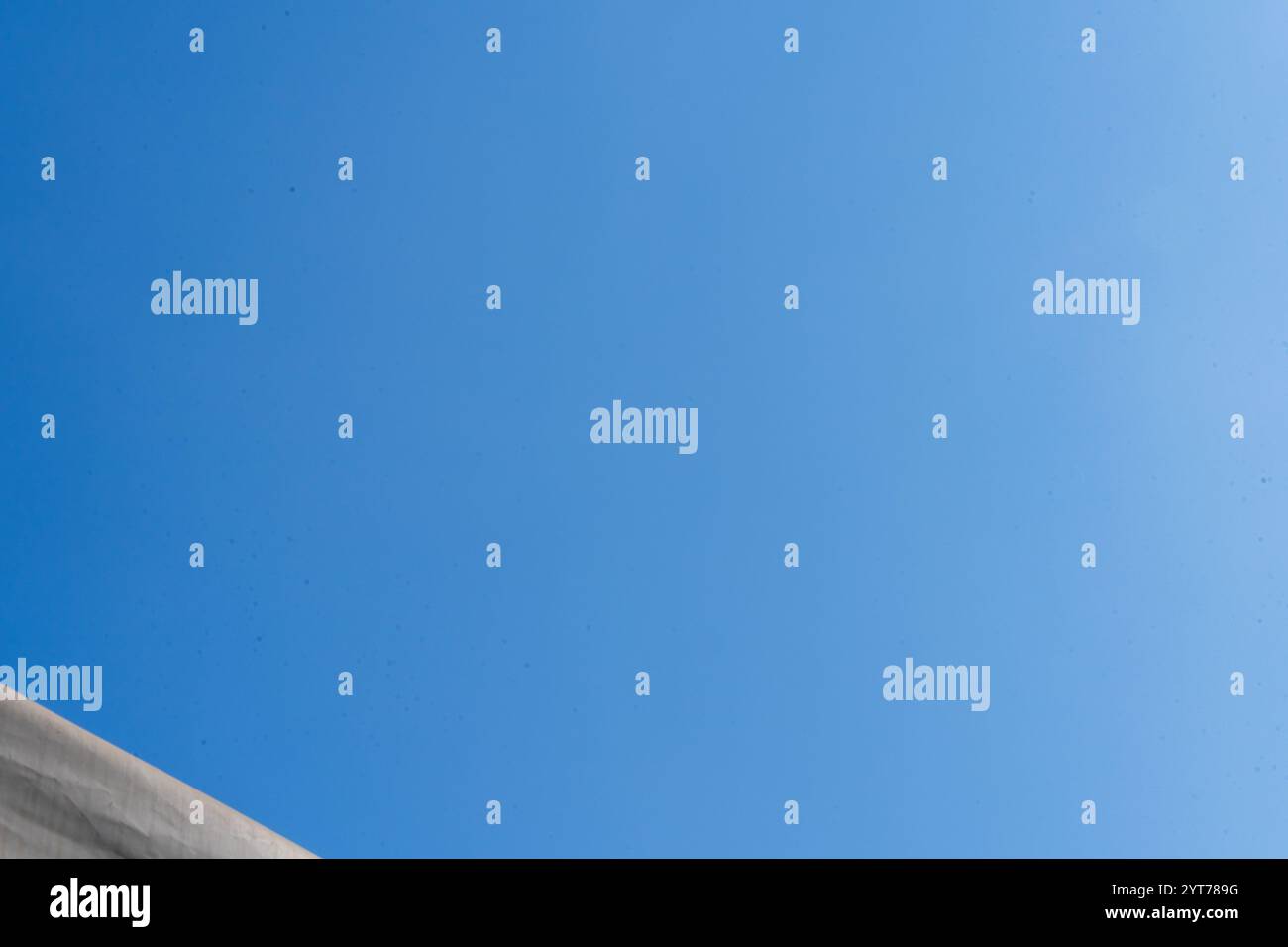 Minimalist composition featuring a clear blue sky and a concrete edge ...