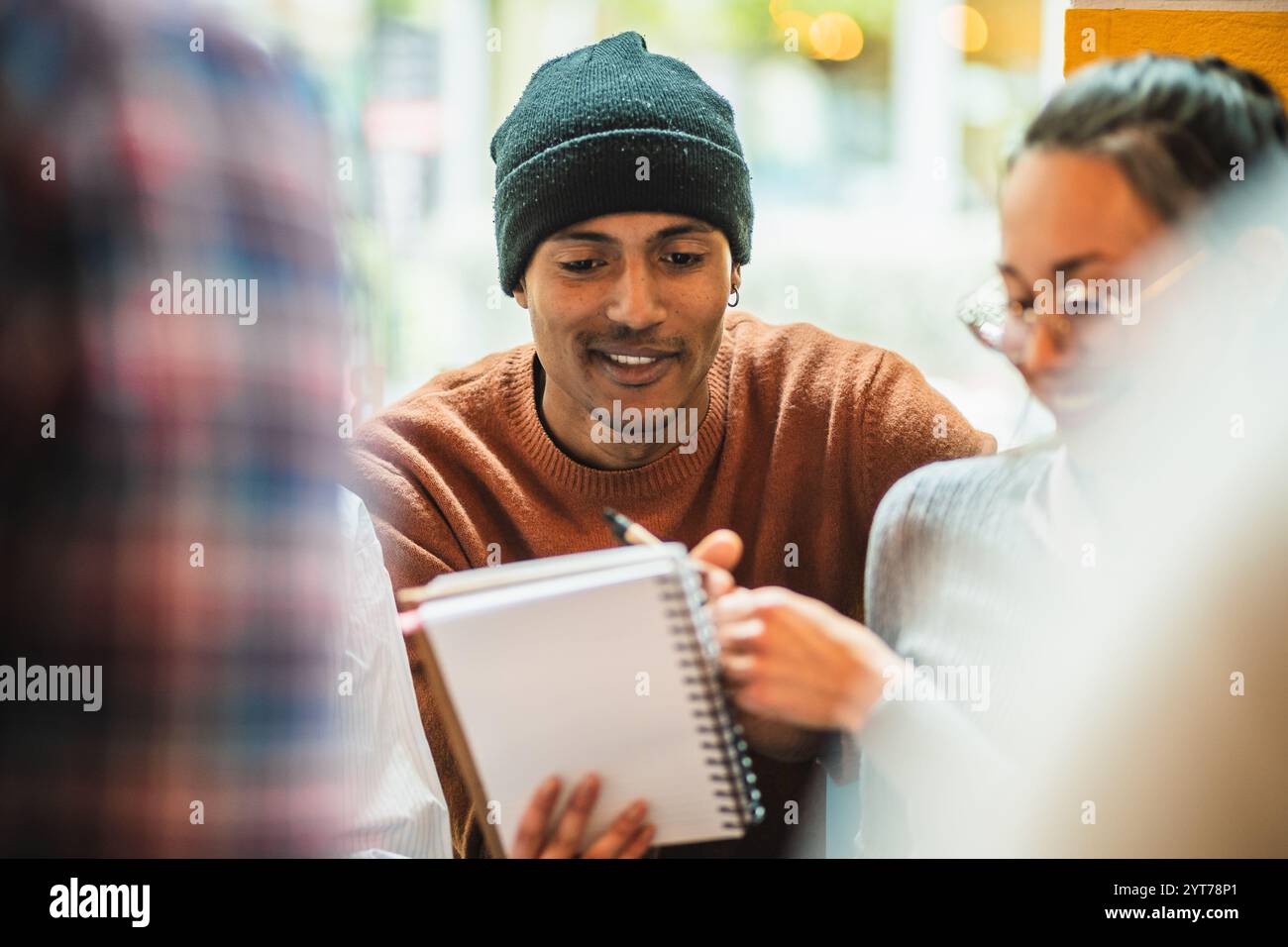 University students are collaborating on a project, sharing notes, and ...