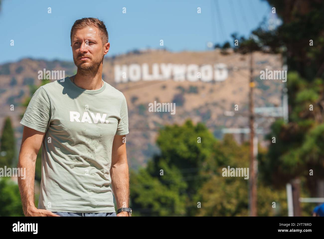 Man Posing in Front of Iconic Hollywood Sign in Los Angeles Stock Photo ...