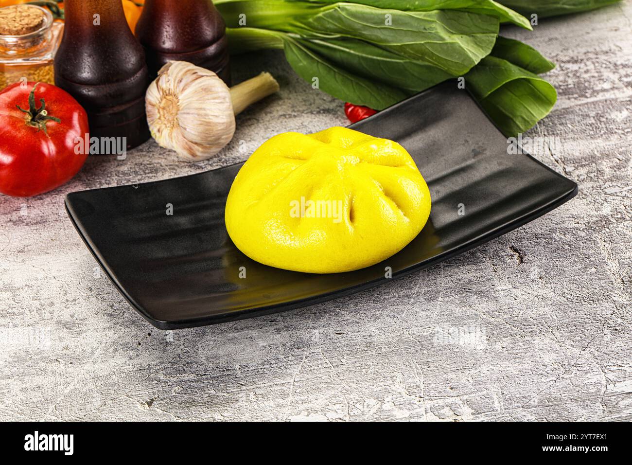 Asian stuffed steamed yellow Bun Bao Stock Photo - Alamy