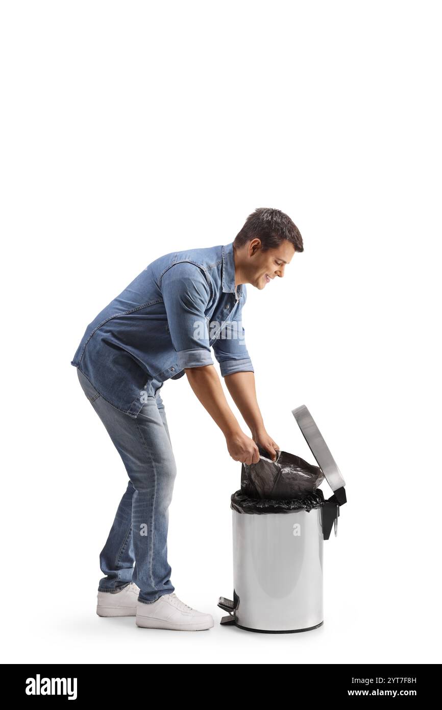 Man putting a plastic liner bag in a trash can isolated on white ...