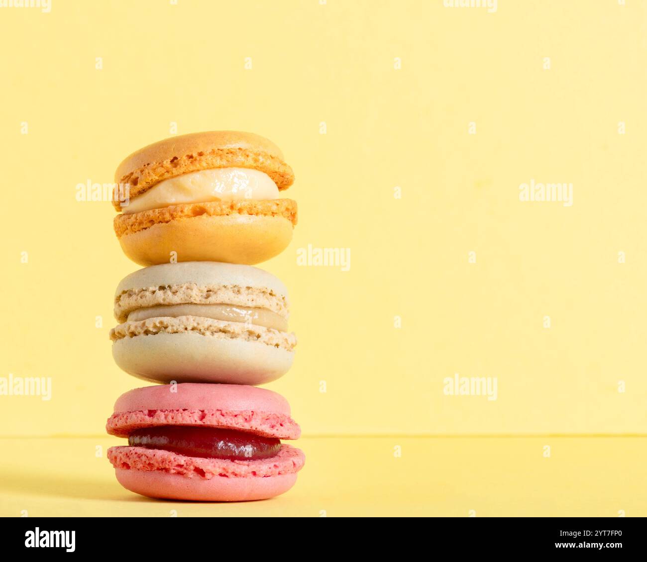 trio of colourful macarons ivarious flavors and pastel shades, placed ...