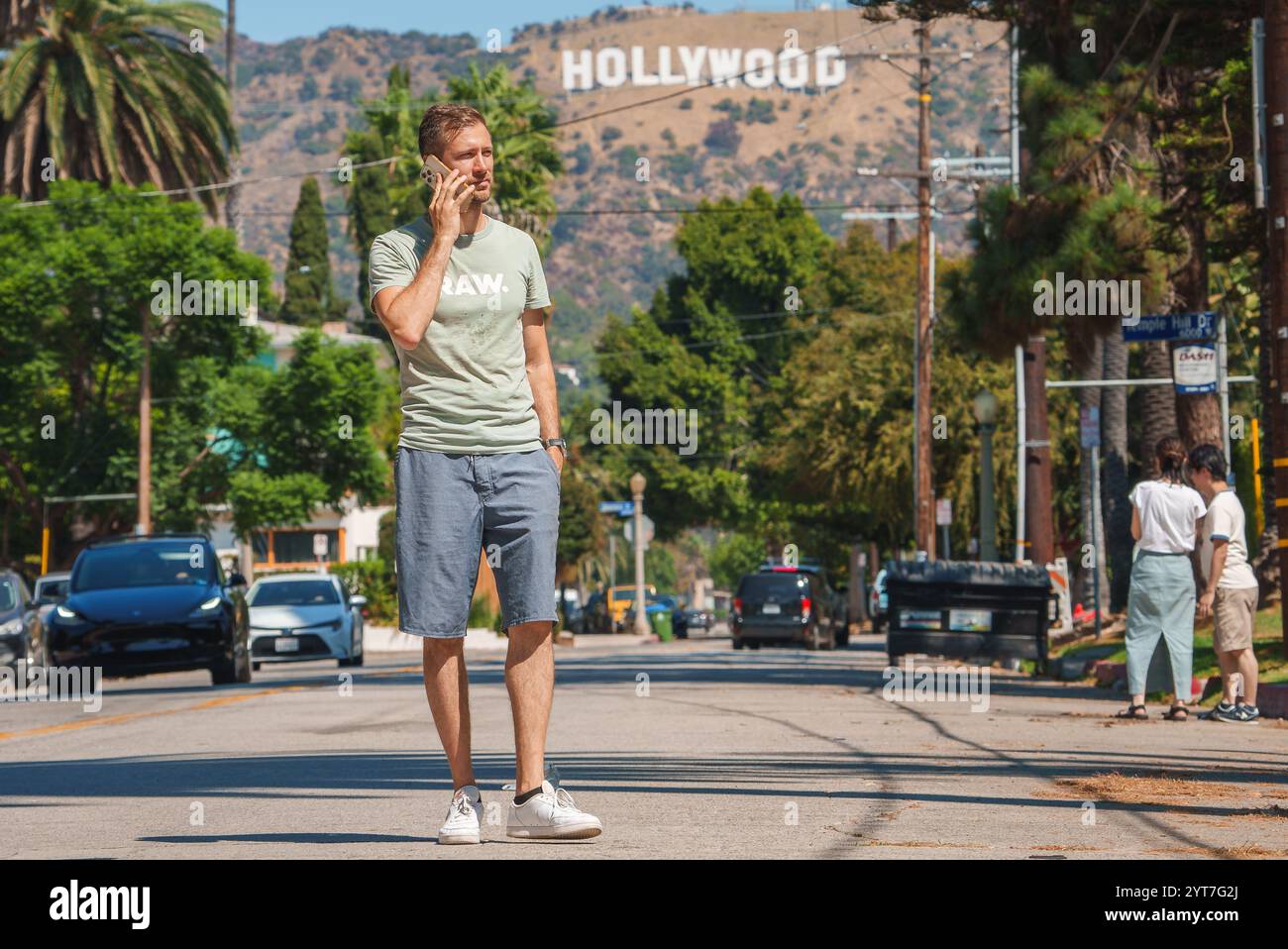 Man on Phone with Hollywood Sign in Los Angeles Urban Street Scene ...