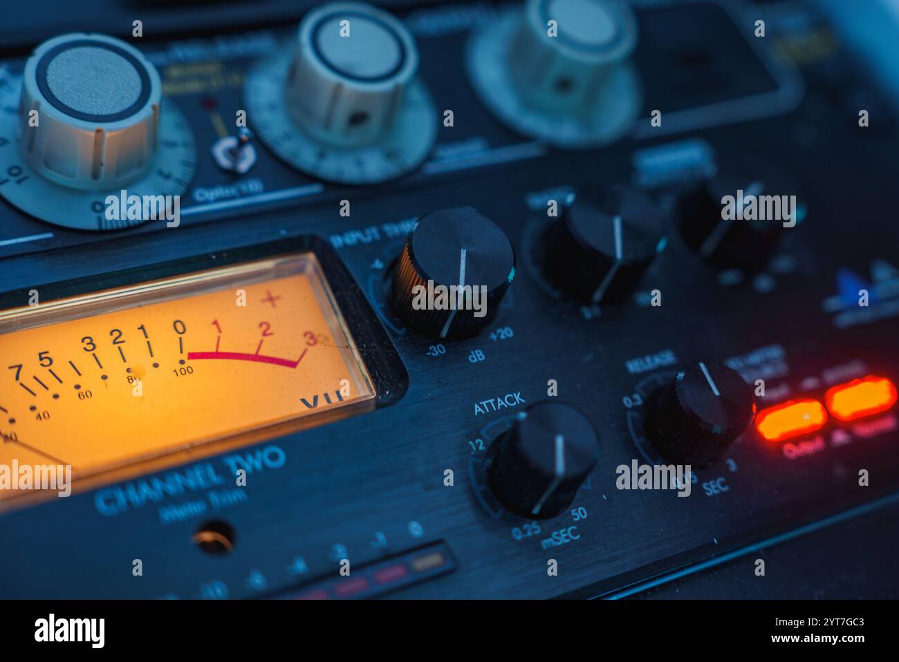 The image shows a detailed view of an audio mixing console, featuring ...