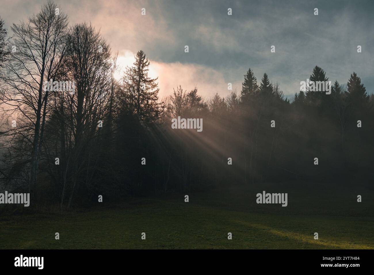 Sun rising through clouds alpine hi-res stock photography and images ...