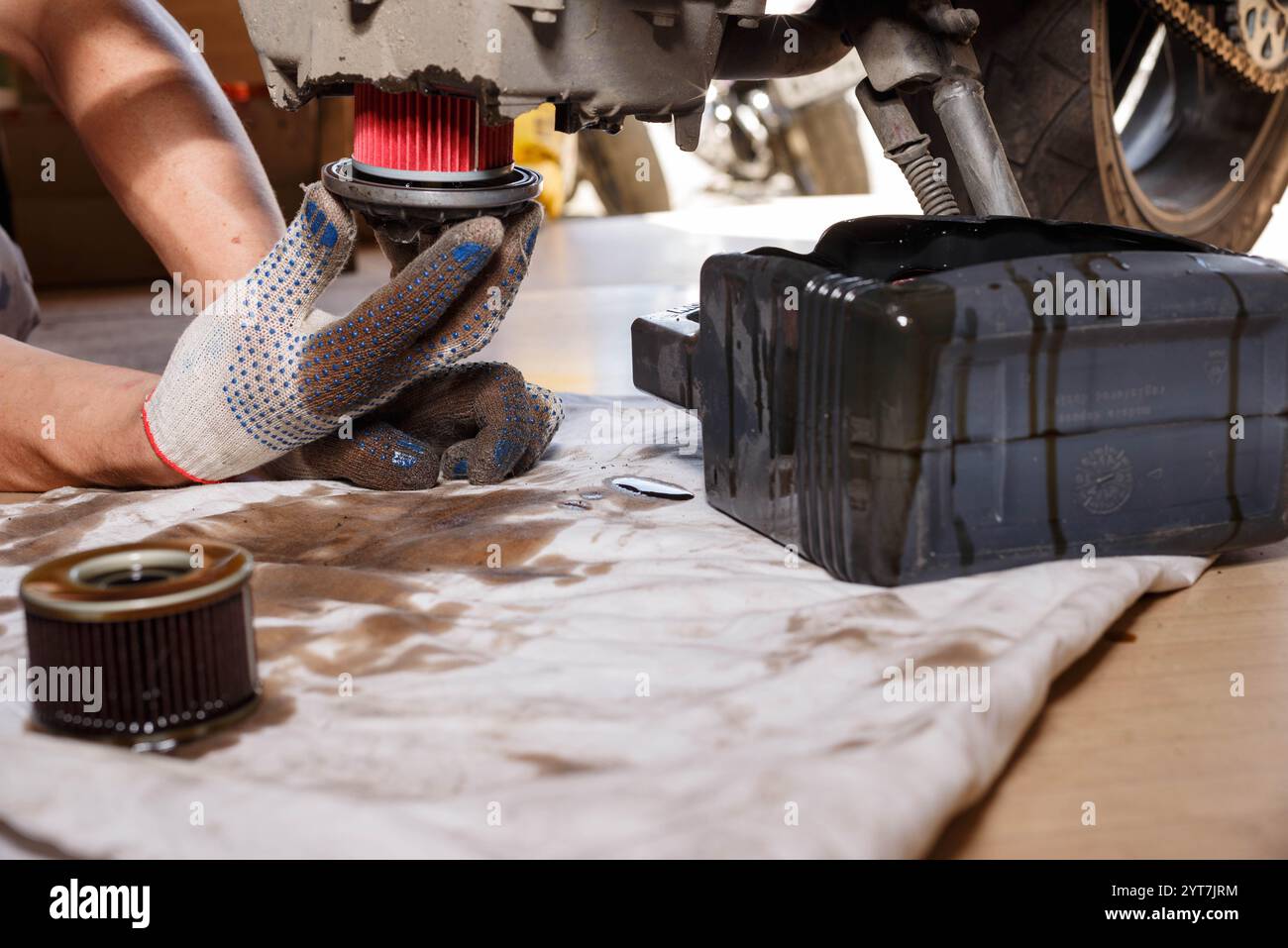 The process of draining oil from a motorcycle engine. Engine oil ...