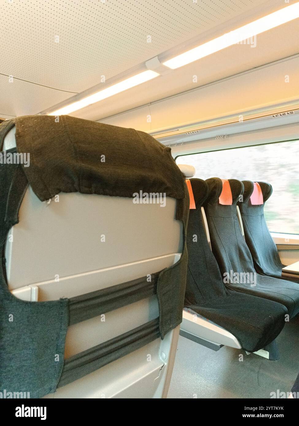 passenger seats in an electric train in black covers. electric train ...