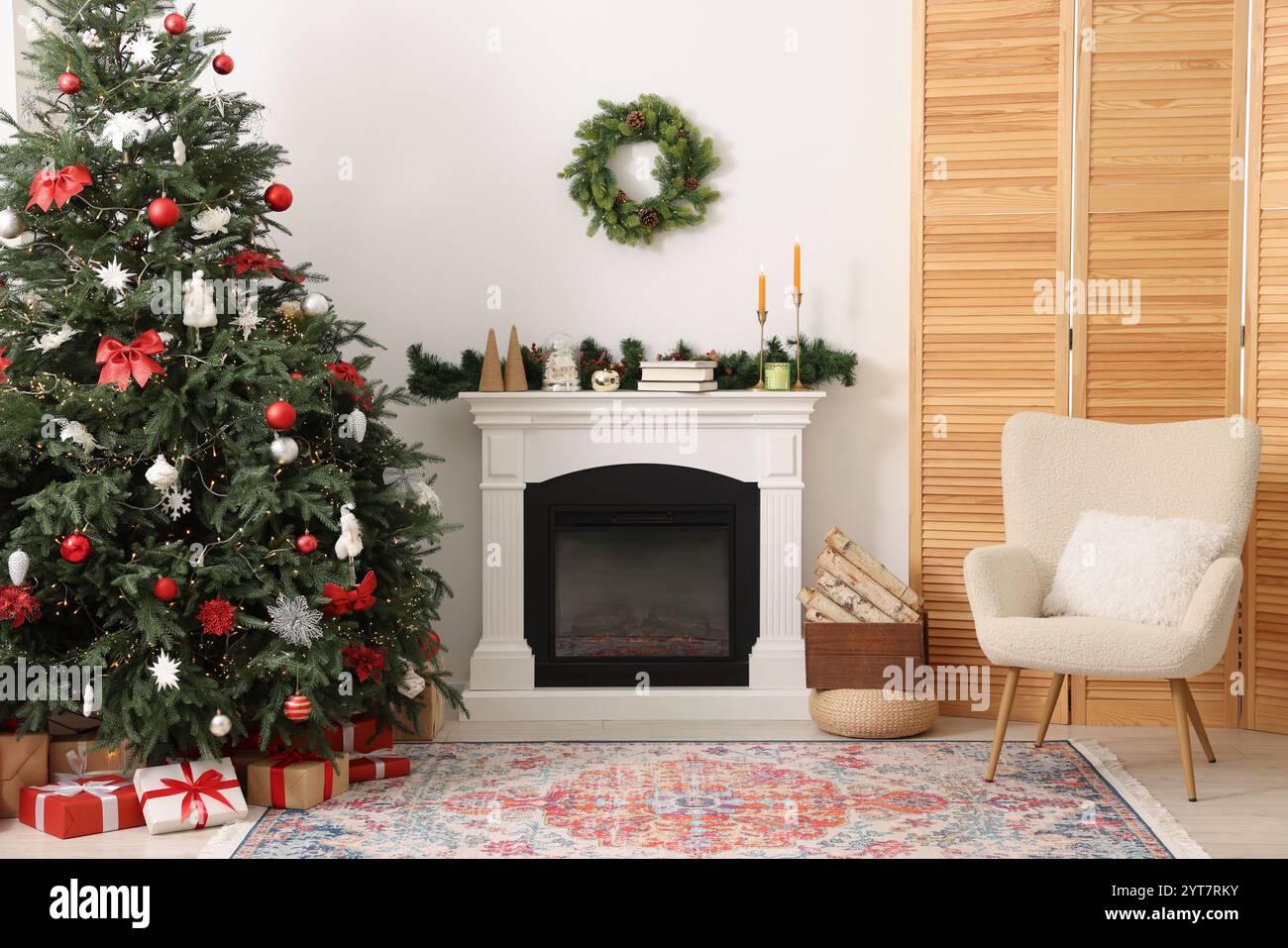 Decorated Christmas tree near fireplace in room. Festive interior ...