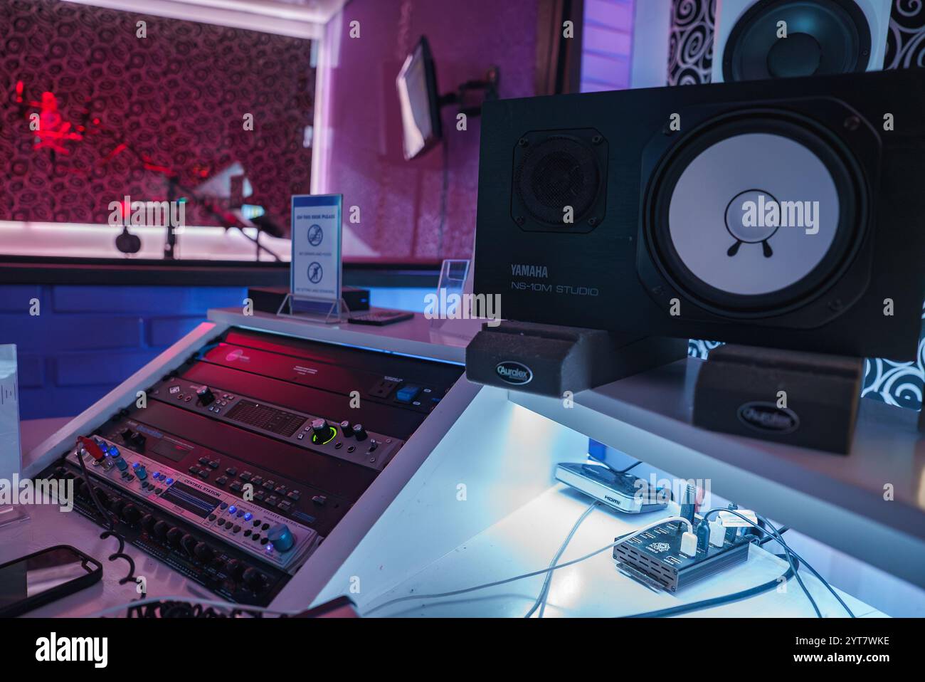 A contemporary recording studio features a Yamaha NS 10M monitor, blue ...