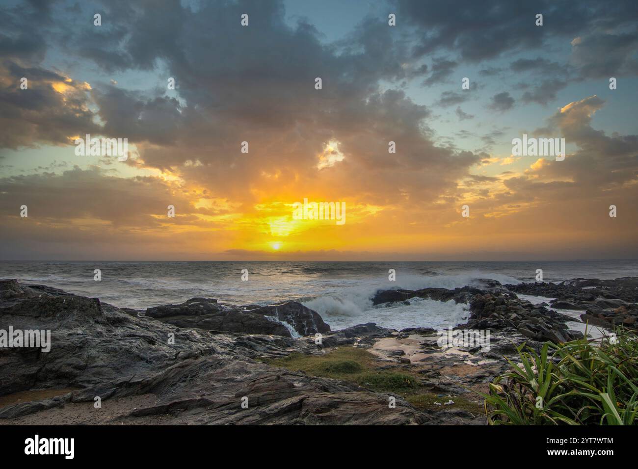 Beach with lava rocks and vegetation, view of the sea in the evening at ...