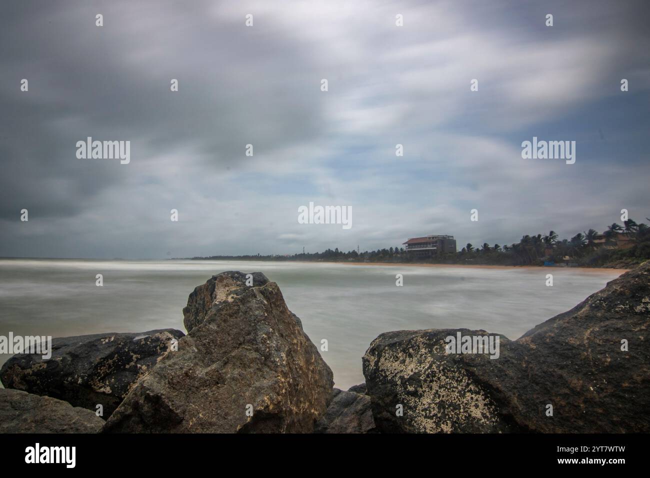 Beach with lava rocks and vegetation, view of the sea in the evening at ...