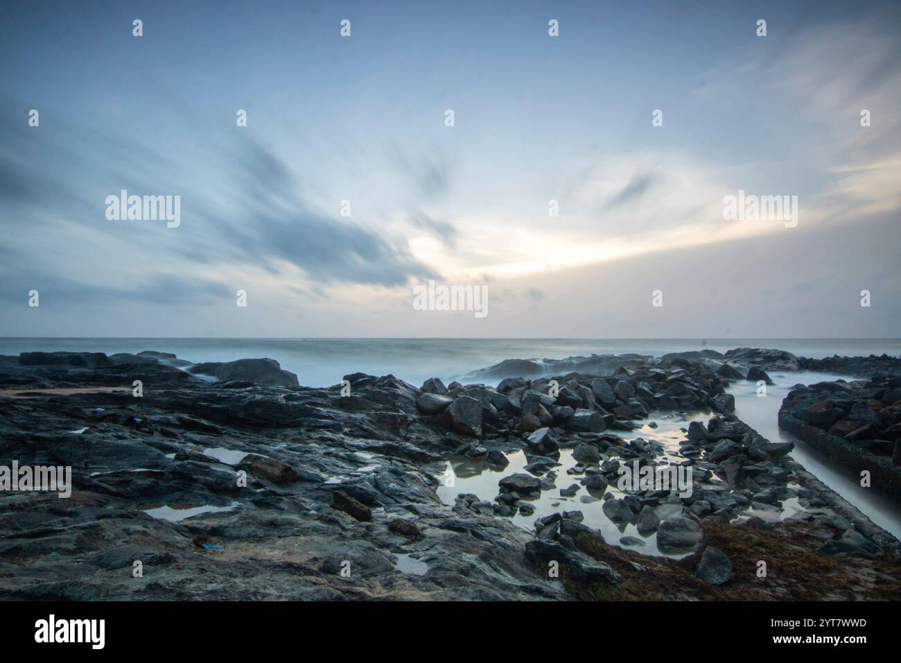 Beach with lava rocks and vegetation, view of the sea in the evening at ...