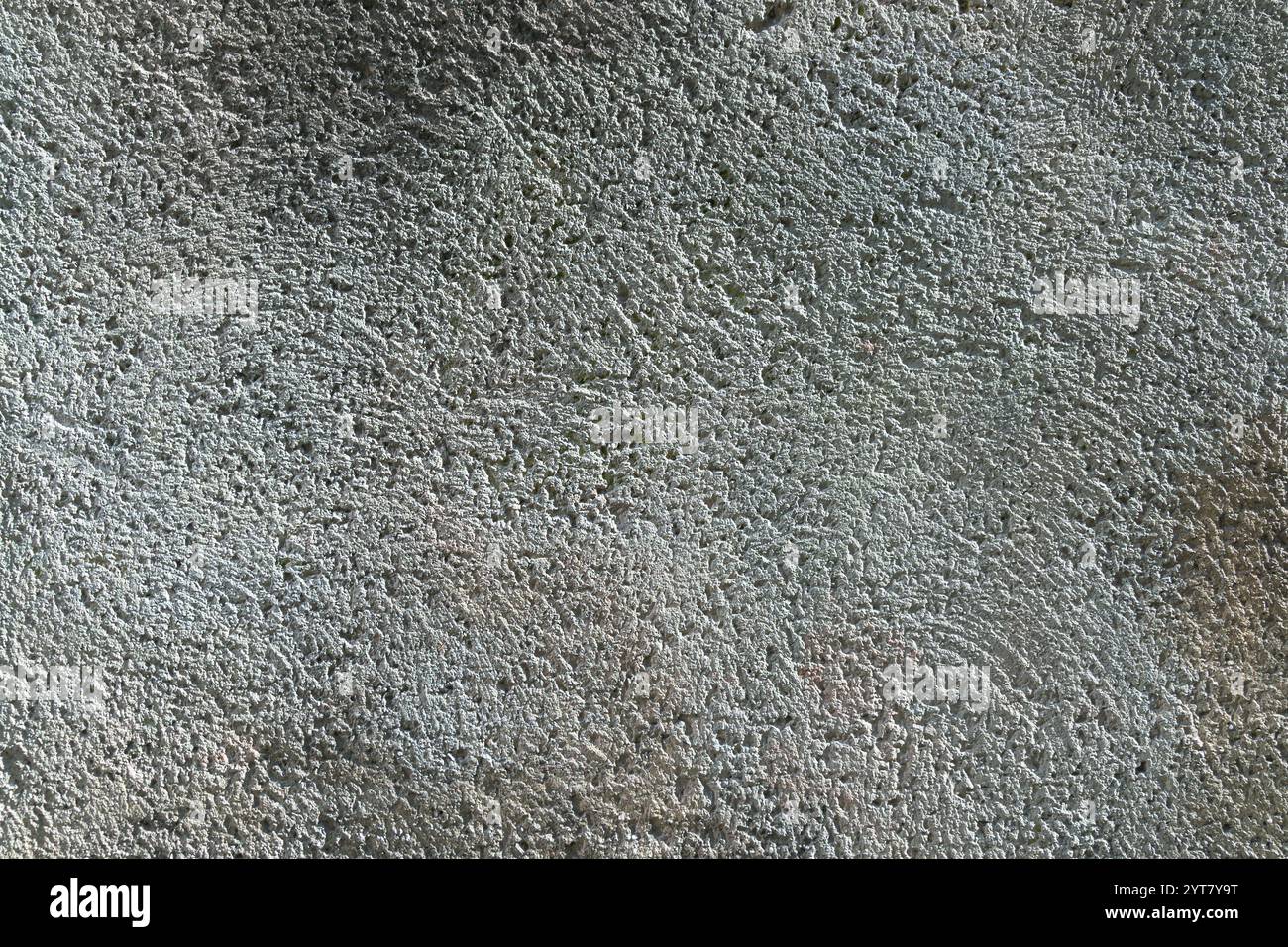 Rough textured concrete wall with natural grooves and shadows, close-up ...