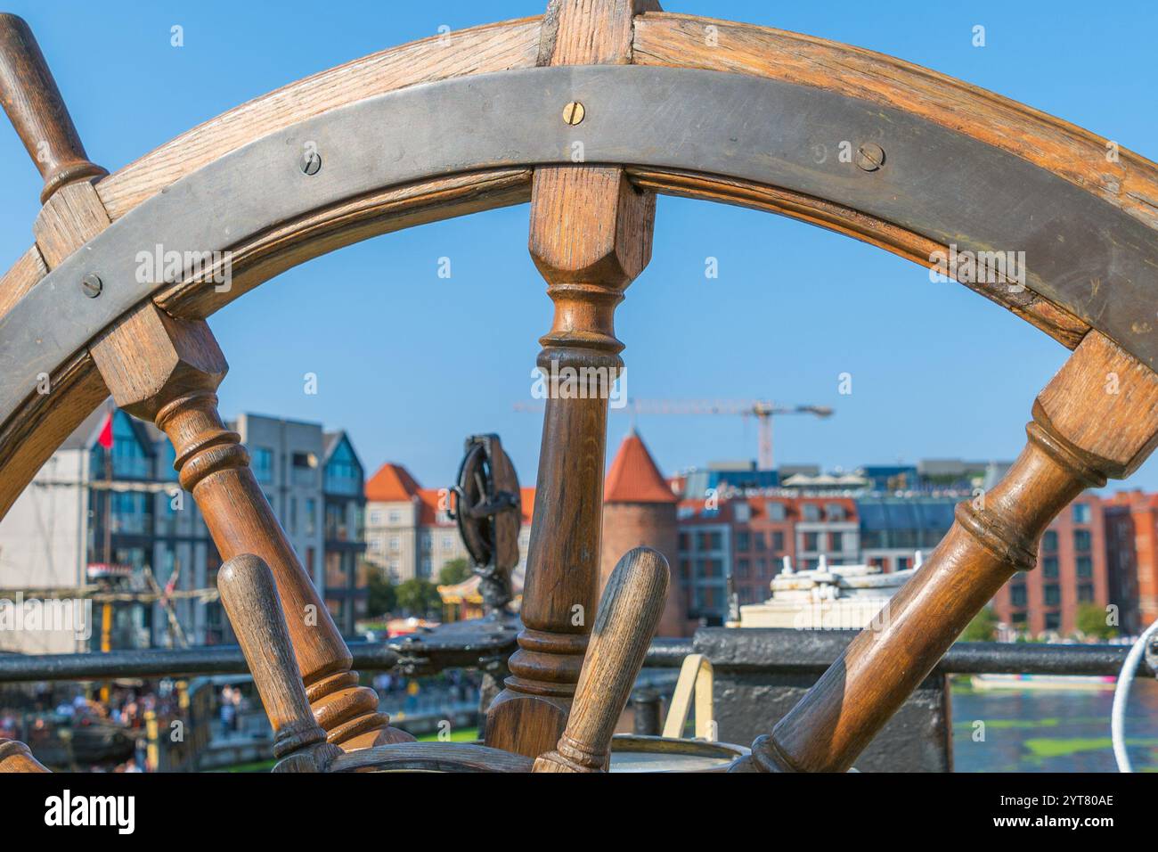 A close-up of a traditional wooden ship's wheel. Ship parts. An old sea ...