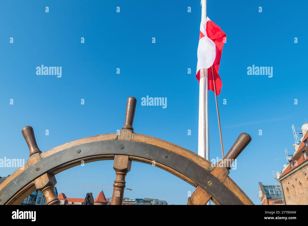A close-up of a traditional wooden ship's wheel. Ship parts. An old sea ...