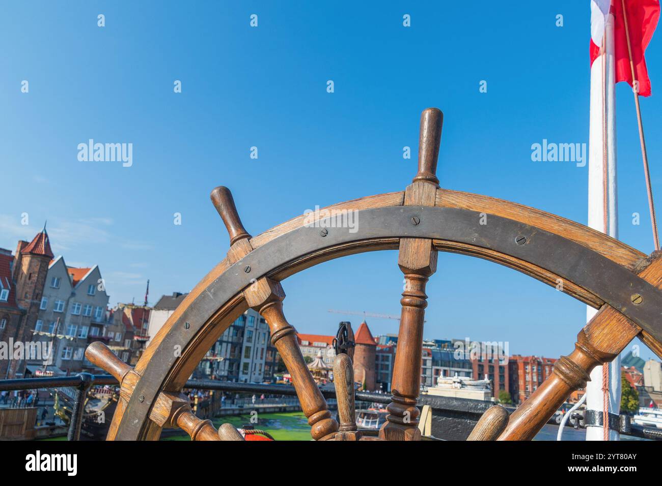 A close-up of a traditional wooden ship's wheel. Ship parts. An old sea ...