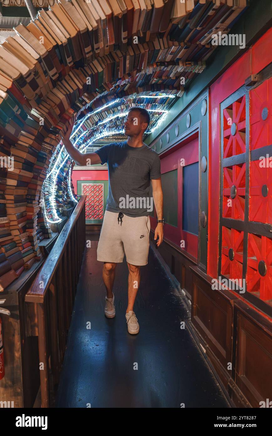Man Walking Through Book Tunnel at The Last Bookstore, Los Angeles ...