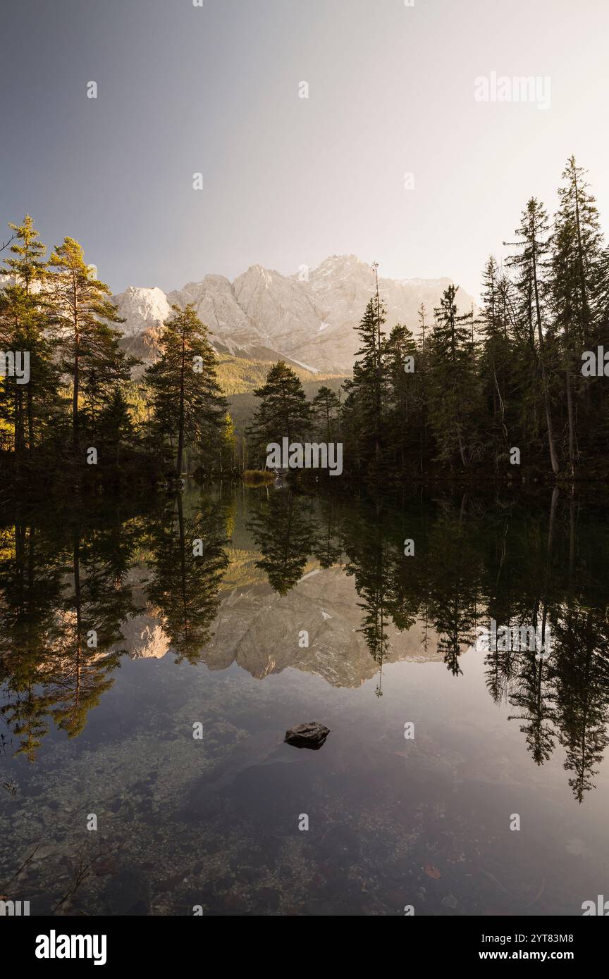 Eibsee in warm fall light with Zugspitze massif in the background and ...
