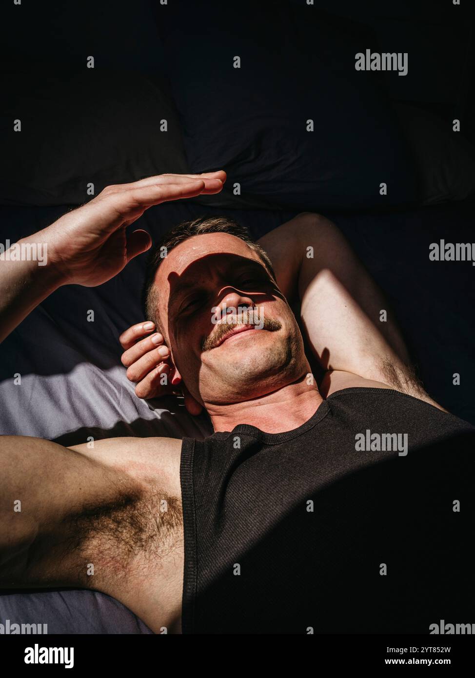Happy man lying on bed hi-res stock photography and images - Alamy