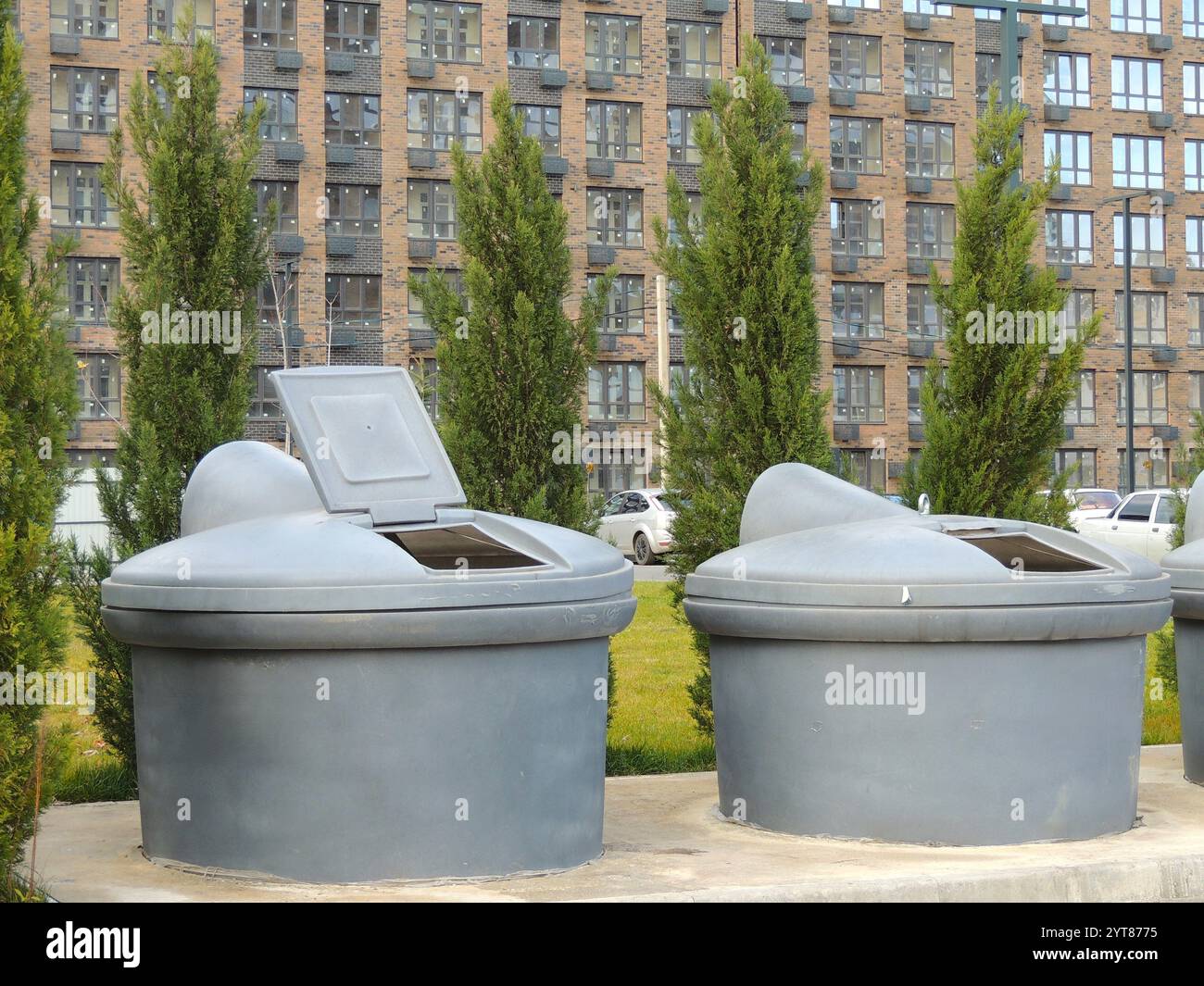two open underground garbage storage tanks in a residential city ...