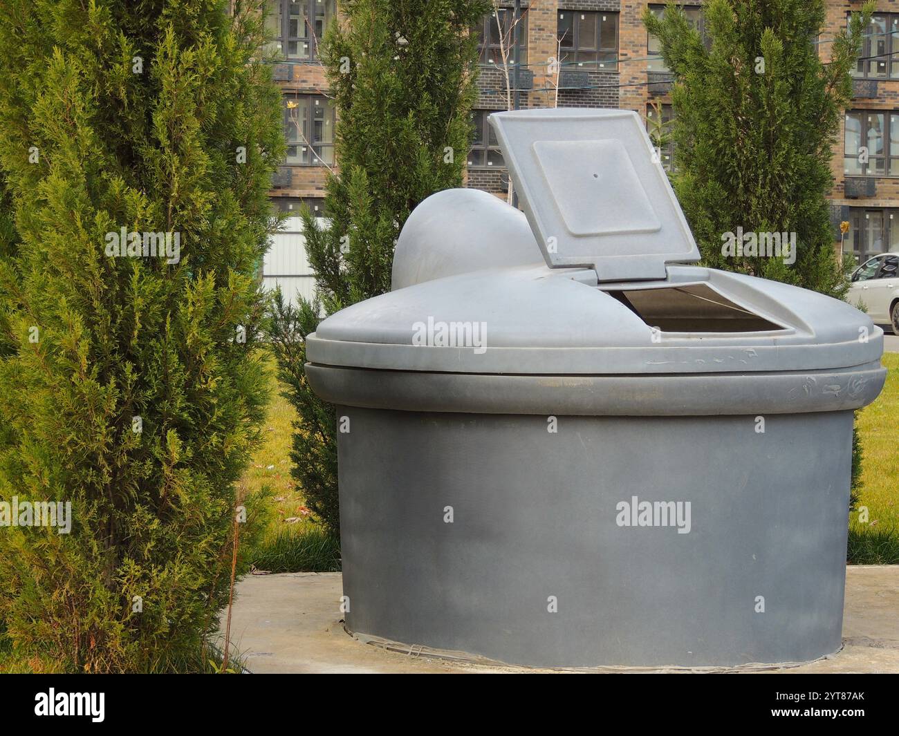 large gray plastic storage container standing in a residential ...