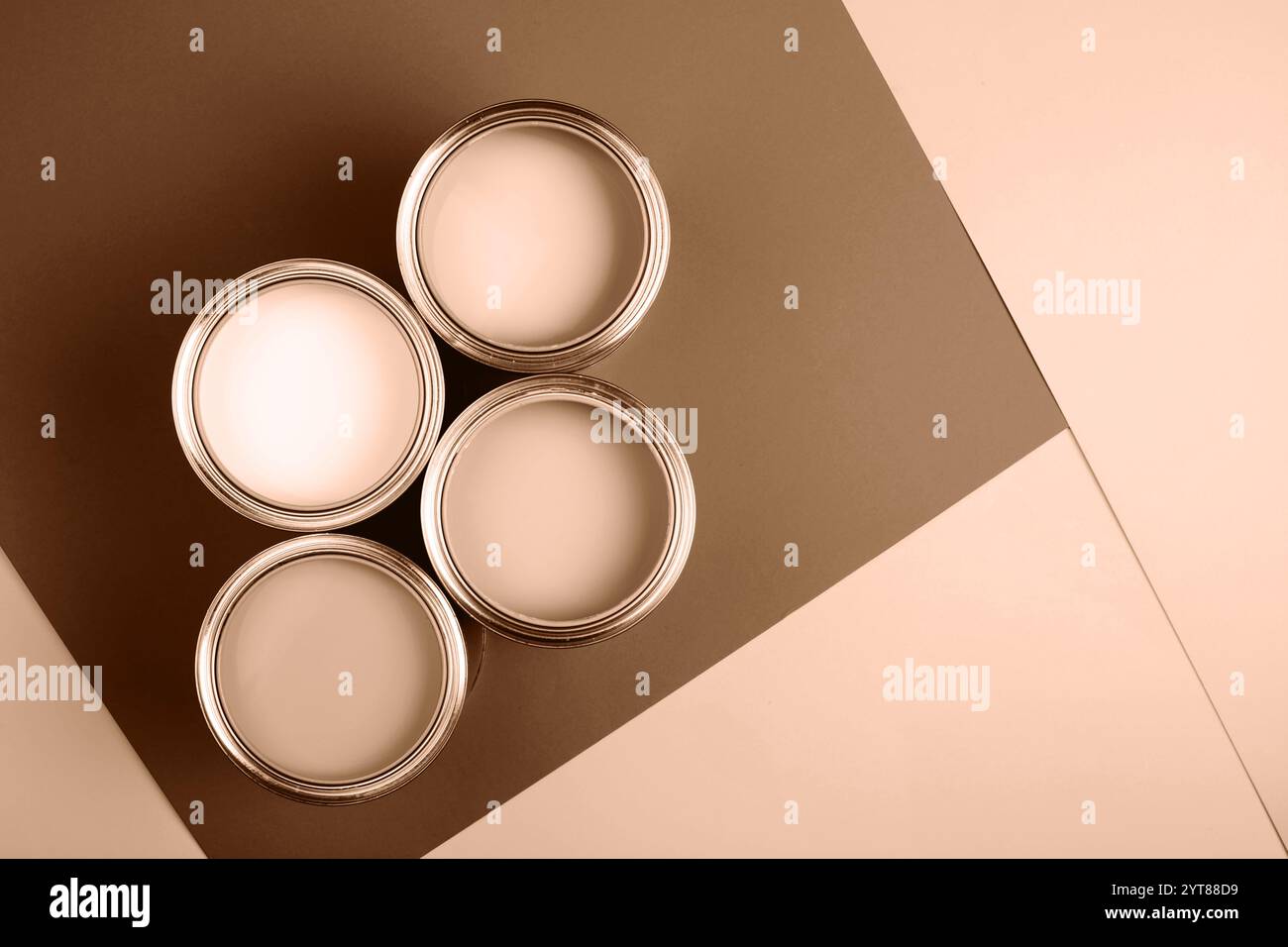 Four paint cans showcasing a rich blend of earthy beige tones Stock ...