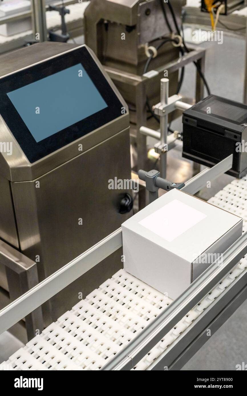 .Vertical photo white carton boxes on the production lines of packing ...