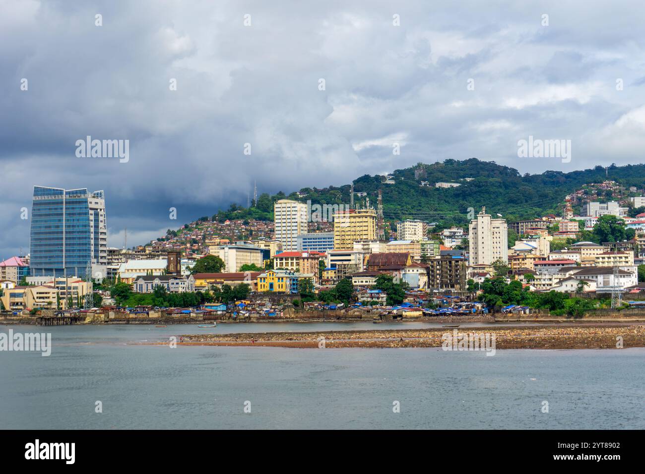 Tropical Skyline of Freetown. Colorful urban waterfront with hills and ...