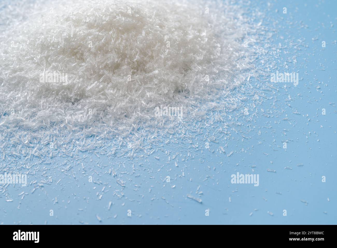 Heap of monosodium glutamate over pastel blue background. Pile of MSG ...
