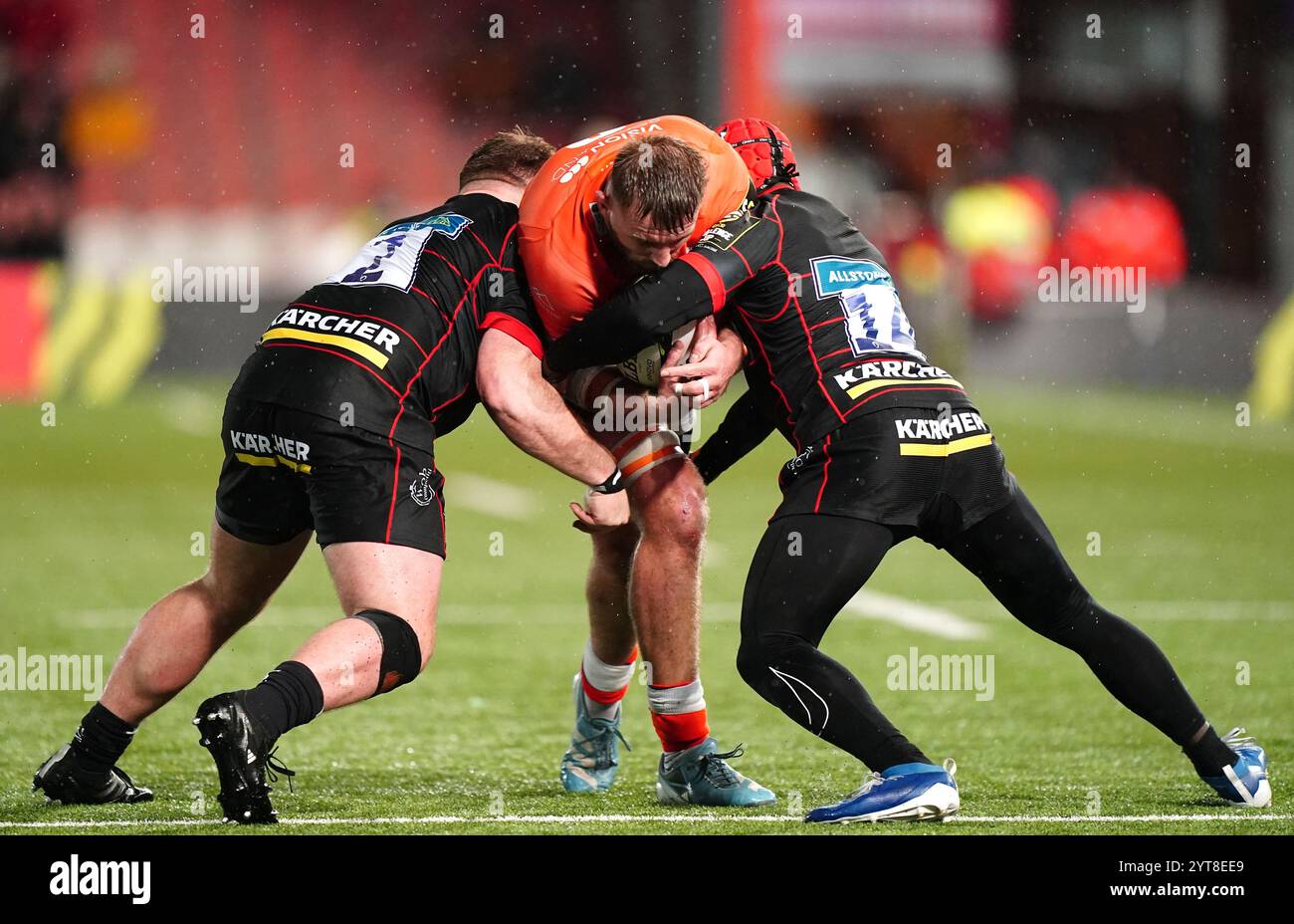 Edinburgh's Tom Dodd (centre) tackled by Gloucester's Seb Blake and ...