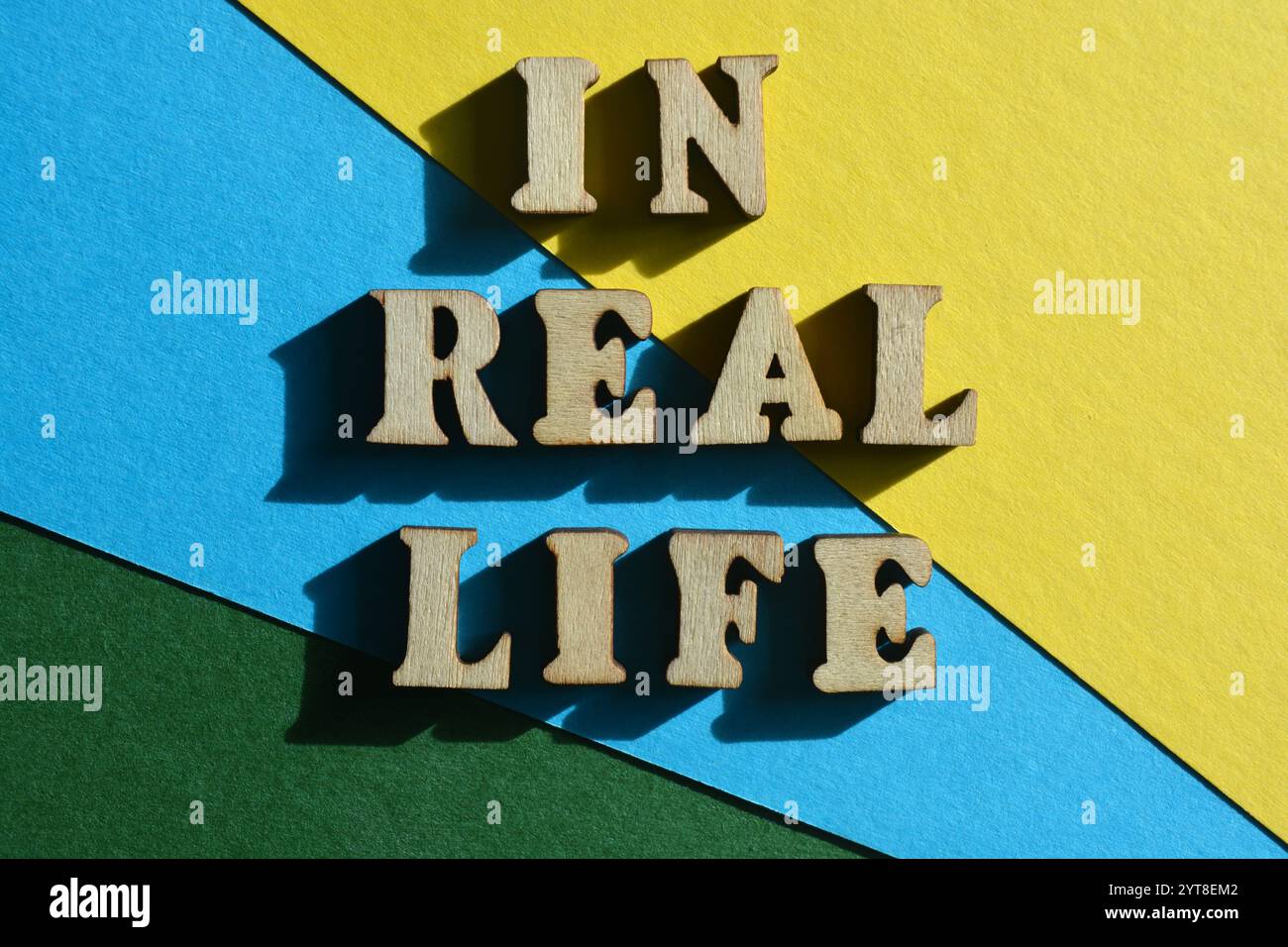 In Real Life, words in wooden alphabet letters isolated on background ...