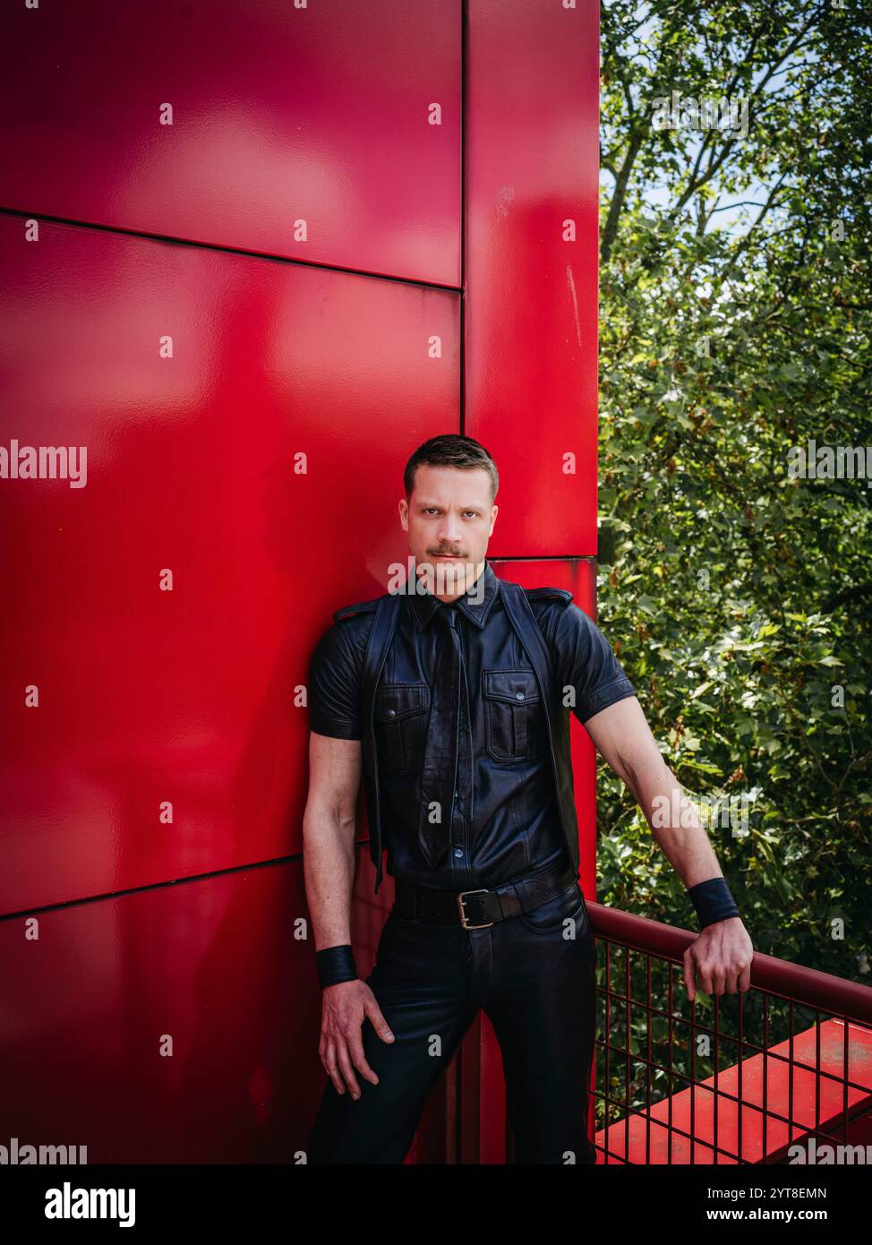 Man in leather outfit on the outside of a building Stock Photo - Alamy