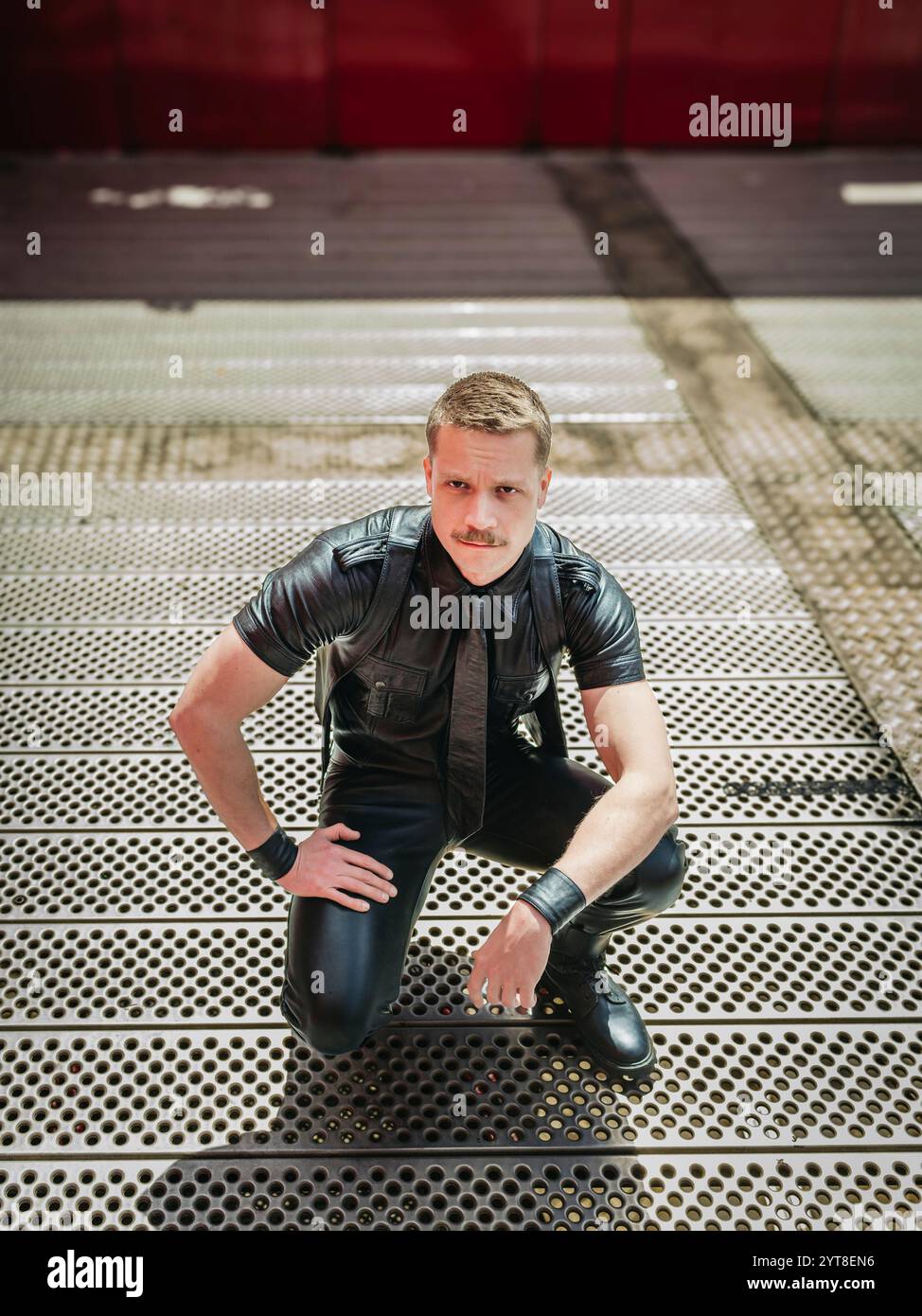 Man in leather outfit on the outside of a building Stock Photo - Alamy