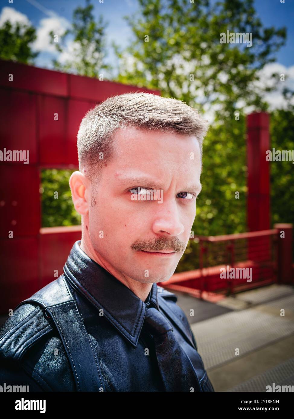 Man in leather outfit on the outside of a building Stock Photo - Alamy