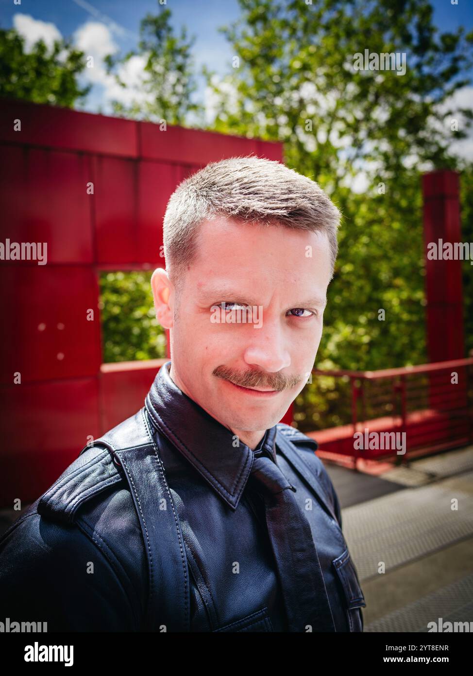 Man in leather outfit on the outside of a building Stock Photo - Alamy