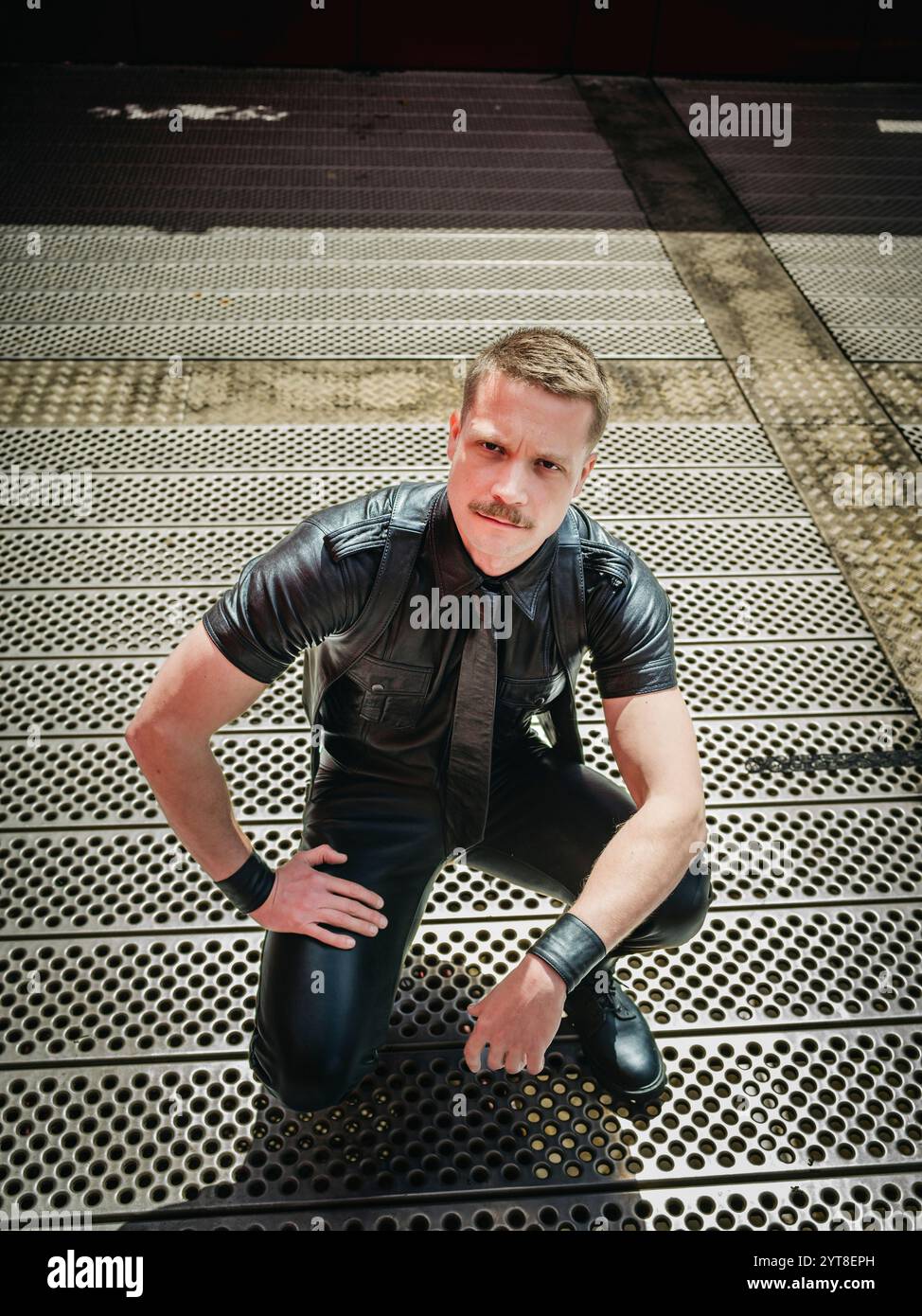 Man in leather outfit on the outside of a building Stock Photo - Alamy
