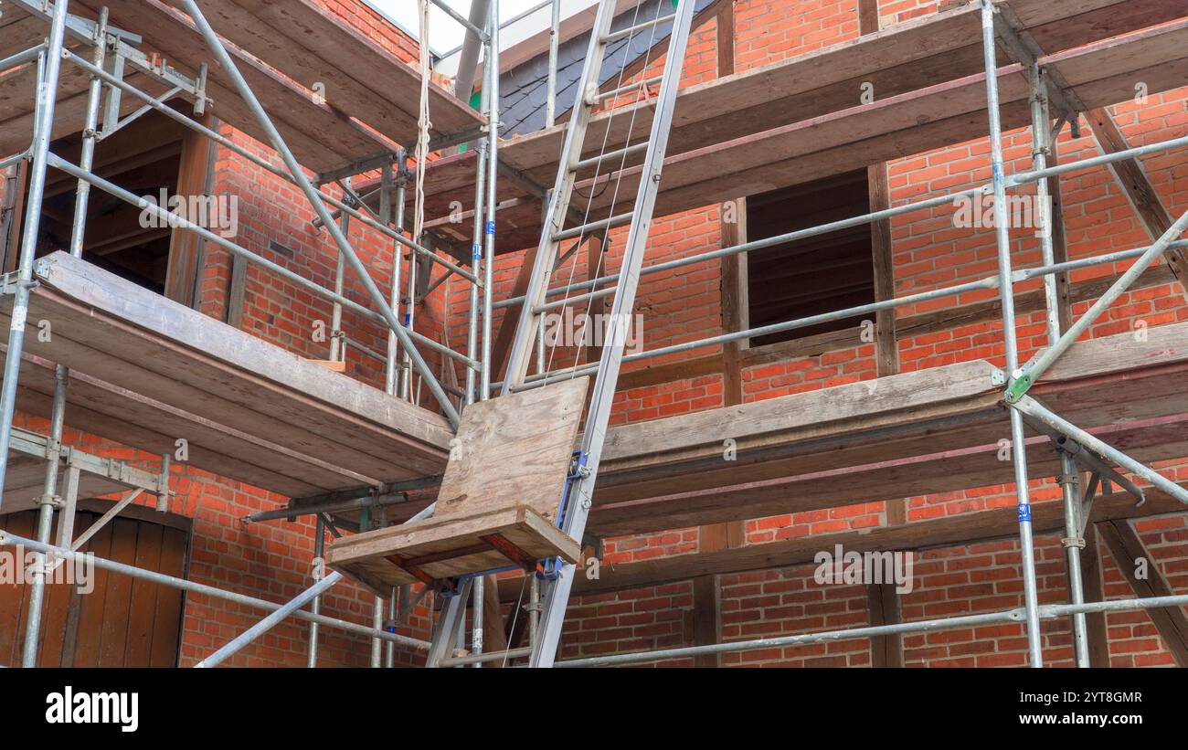 Old brick building with scaffolding Stock Photo - Alamy