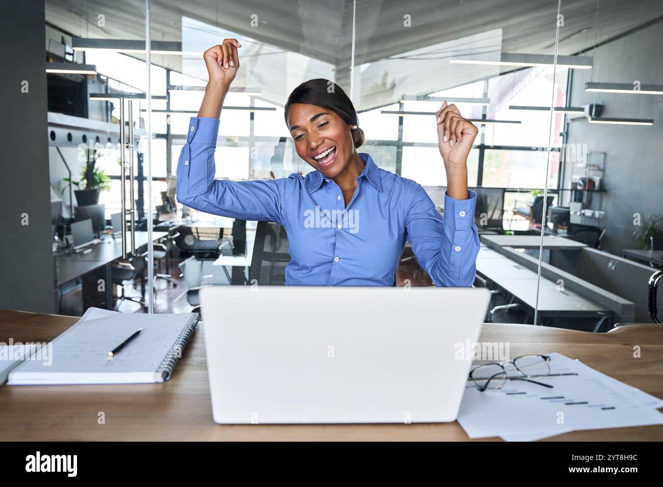 Happy excited African business woman executive celebrating success in ...
