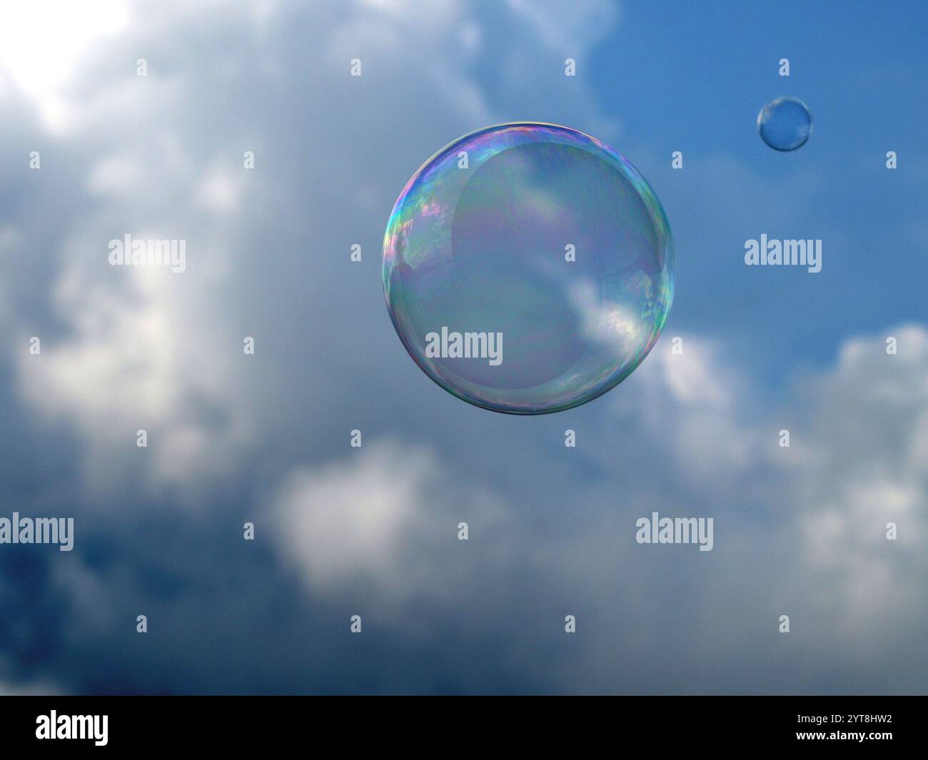 Two soap bubbles float towards the white-blue sky Stock Photo - Alamy