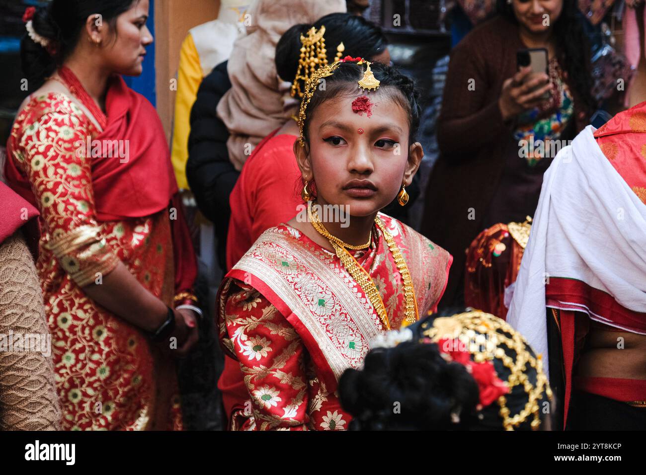 Thamel, Nepal. 6th Dec, 2024. A teen Newari girl dresses in traditional ...