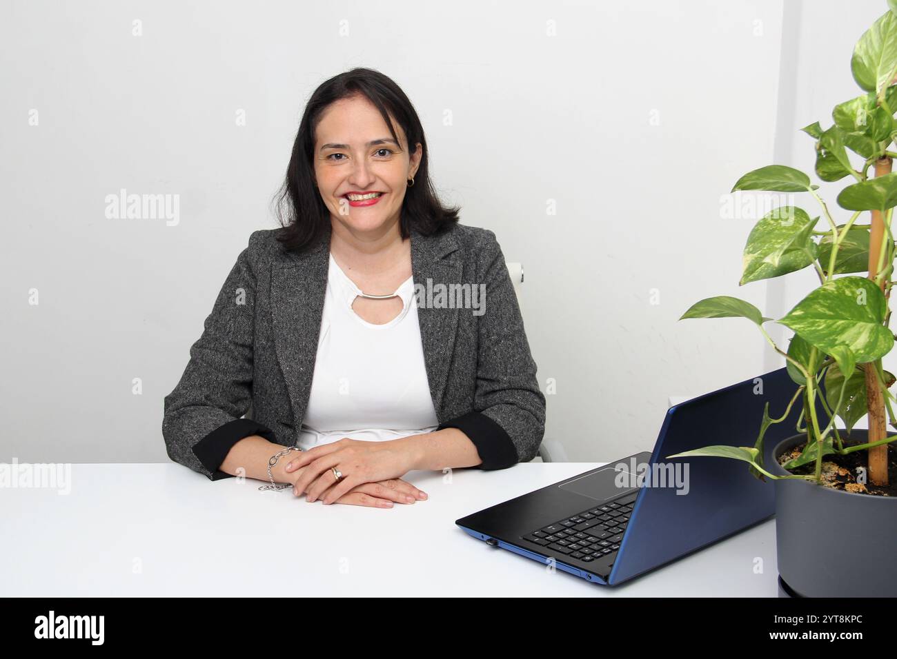 40-year-old woman works in the office with a laptop as an ...