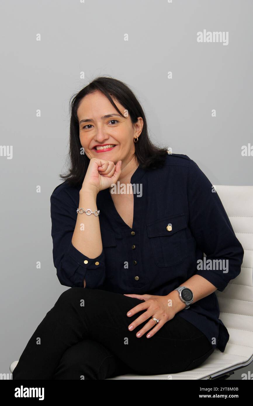 40-year-old executive woman in her office chair shows her leadership ...
