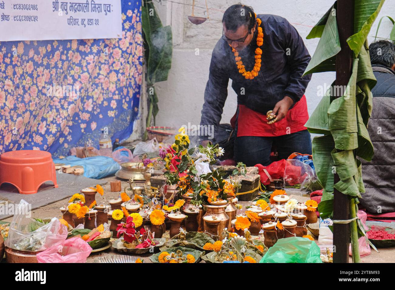Thamel, Nepal. 6th Dec, 2024. A Newari man puts offerings at the Bel ...