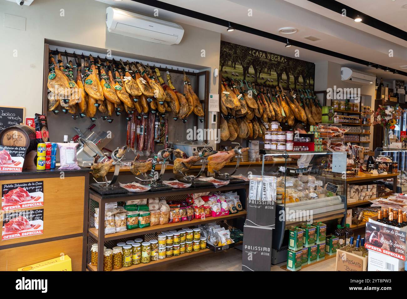 Grocery store with traditional cured ham for sale in Ronda, Andalusia ...