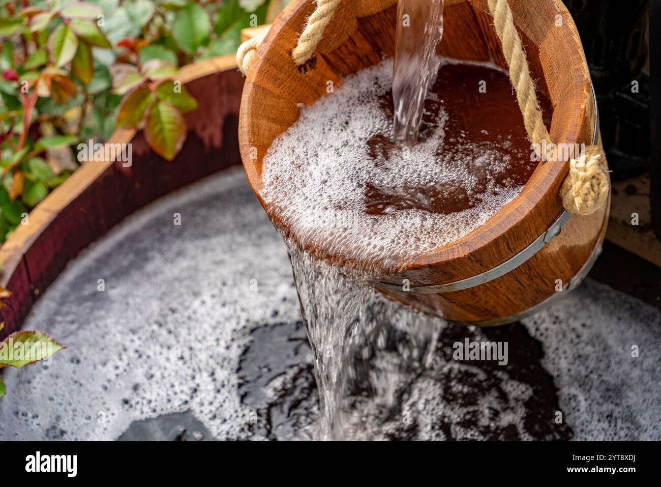 Wooden bucket fountain with flowing water into a wooden barrel Stock ...